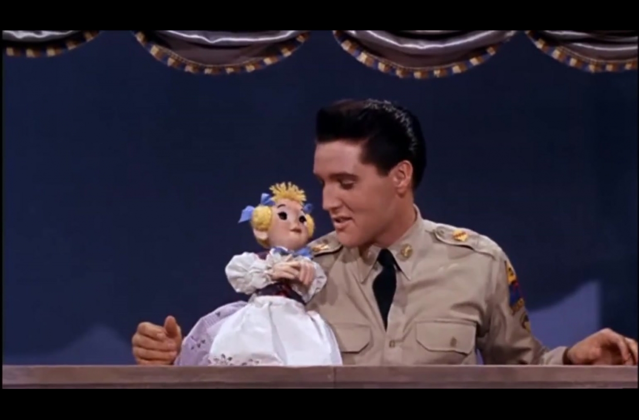 Elvis Presley sings "Wooden Heart" with a puppet.