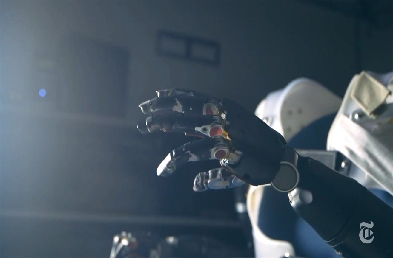 Double amputee practices using bionic, mind-controlled arms.