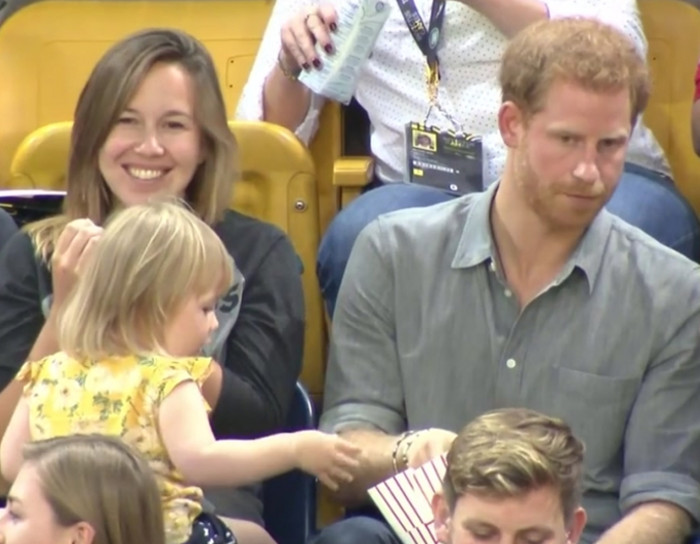 Toddler steals Prince Harry's popcorn.