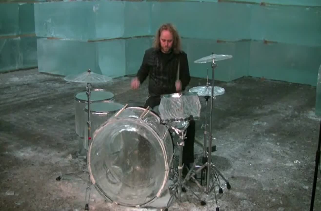 Guy plays a drum kit made out of ice.