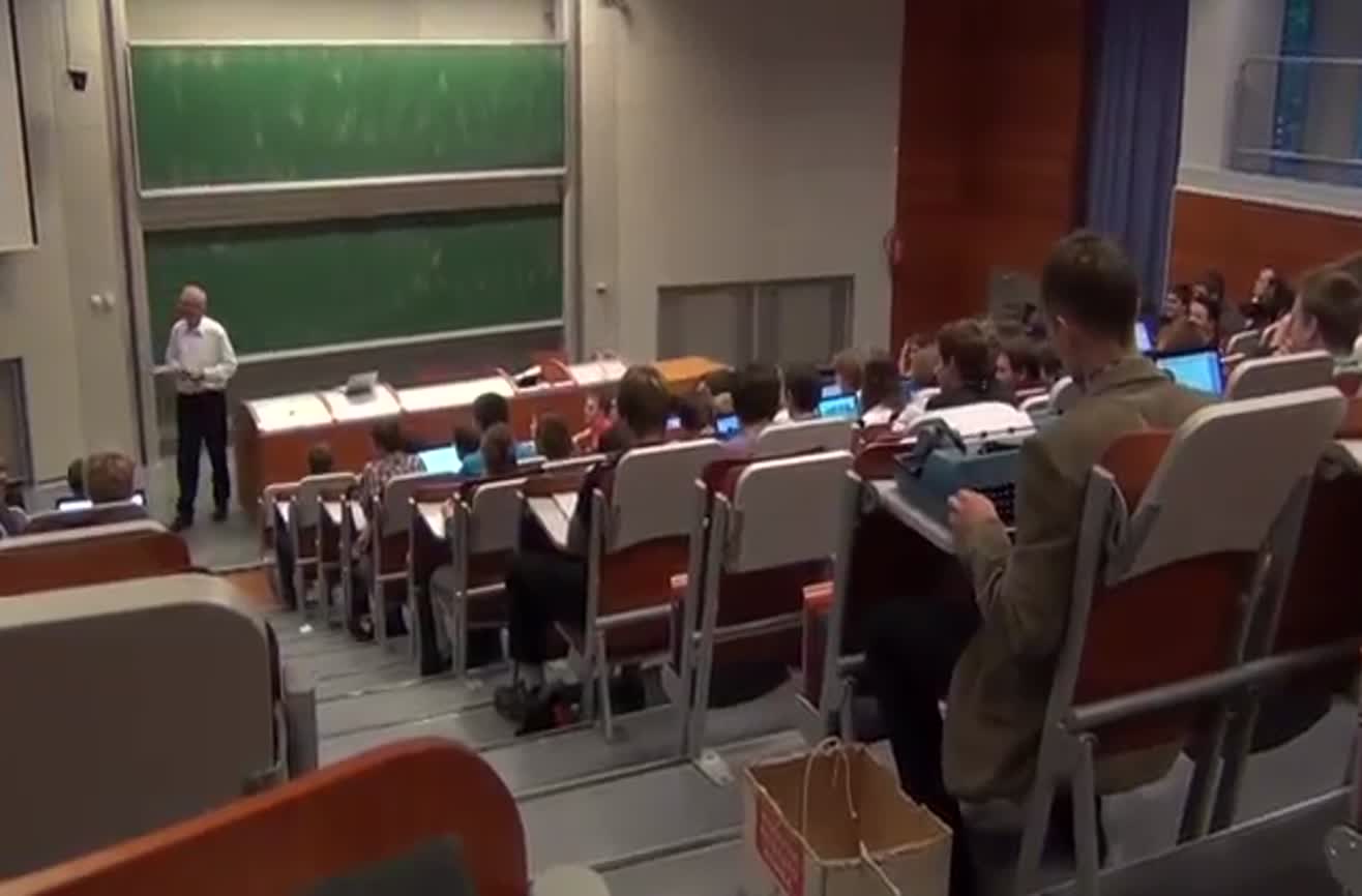 Student brings typewriter to class.