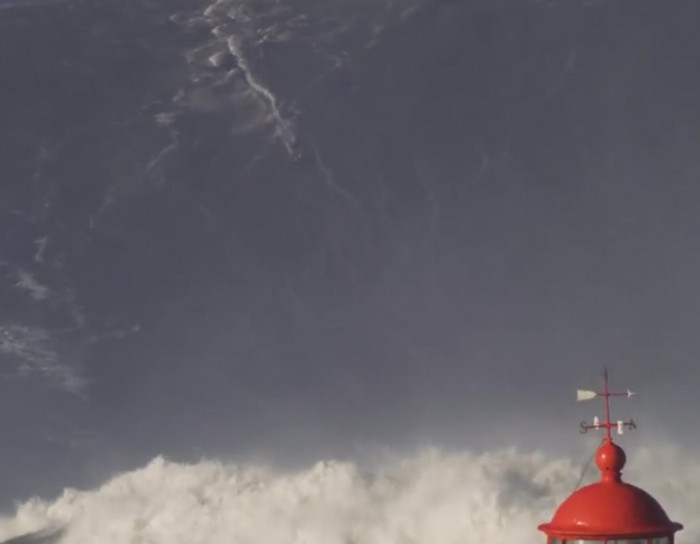 Surfer catches a terrifyingly huge wave.