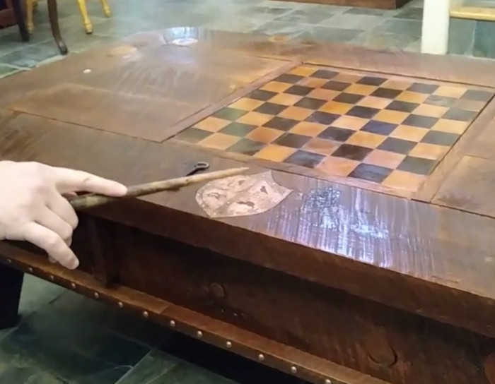 Guy shows off a seriously cool hidden compartment table.