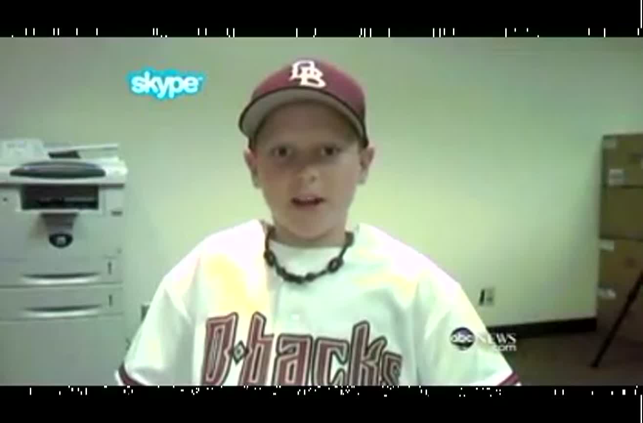 Generous boy gives away his baseball to another little boy.