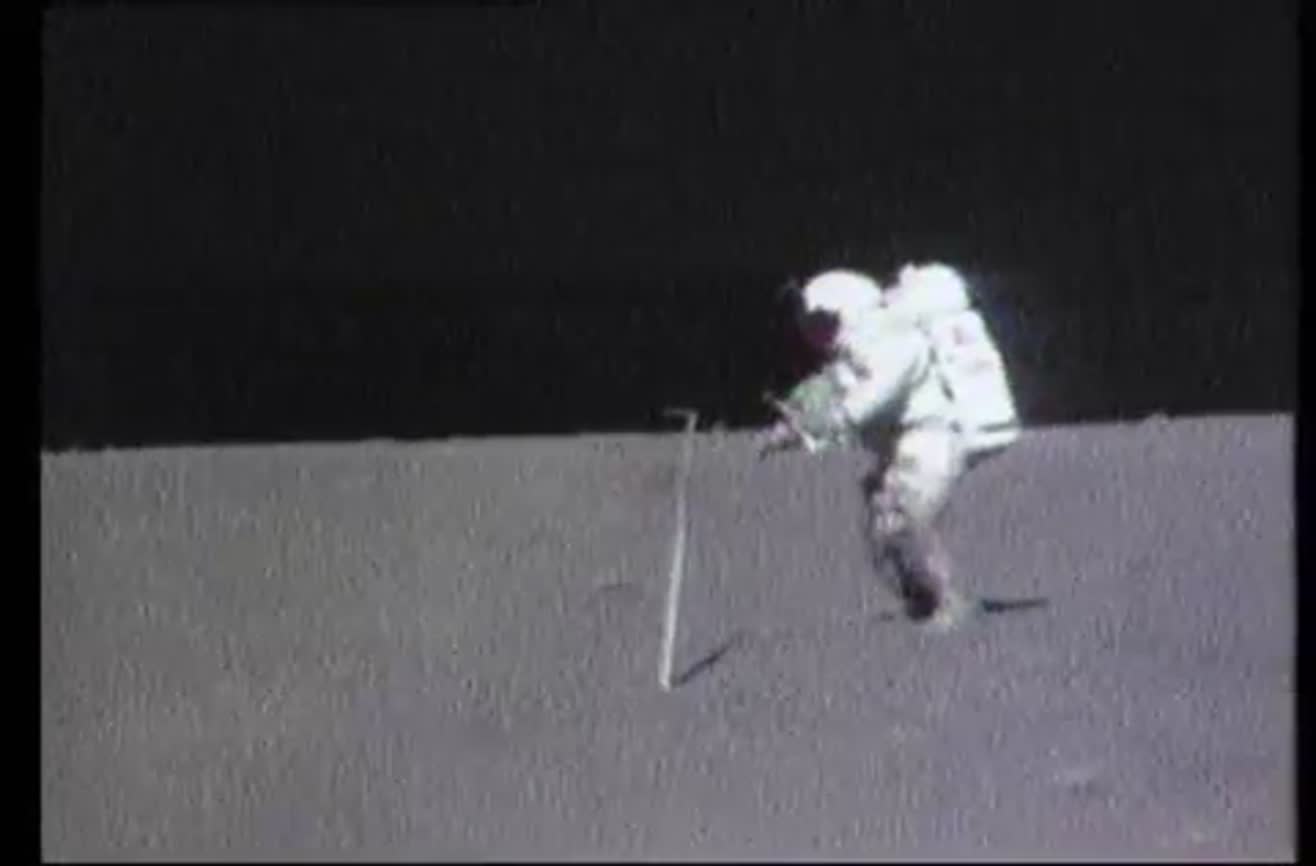 Astronaut Charles Duke attempts to pick up a hammer on the Moon.