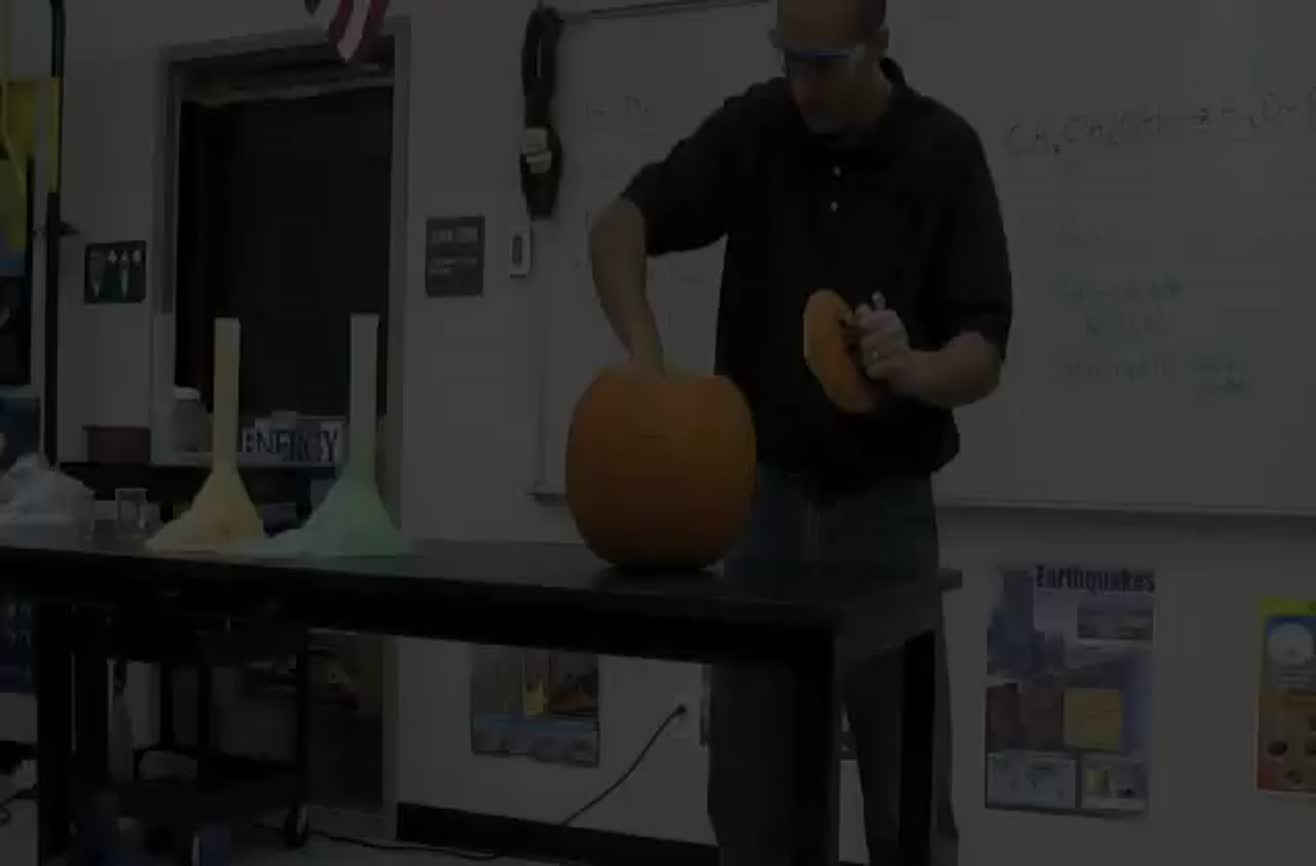 Chemistry teacher carves pumpkin using science.