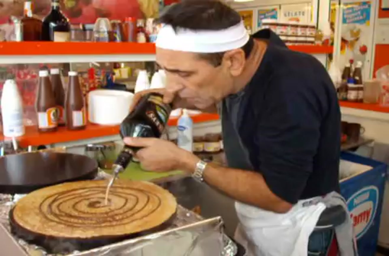 Crepe man celebrates life while making crepes.