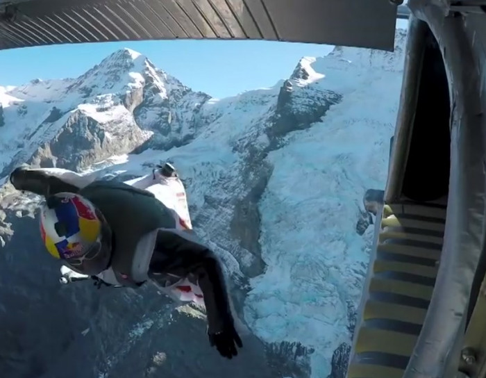 Two wingsuit flyers base jump into a plane in mid-air.