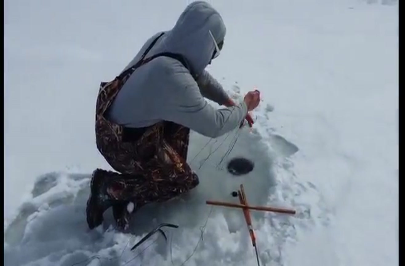 Two ice fishermen get the ultimate surprise catch.