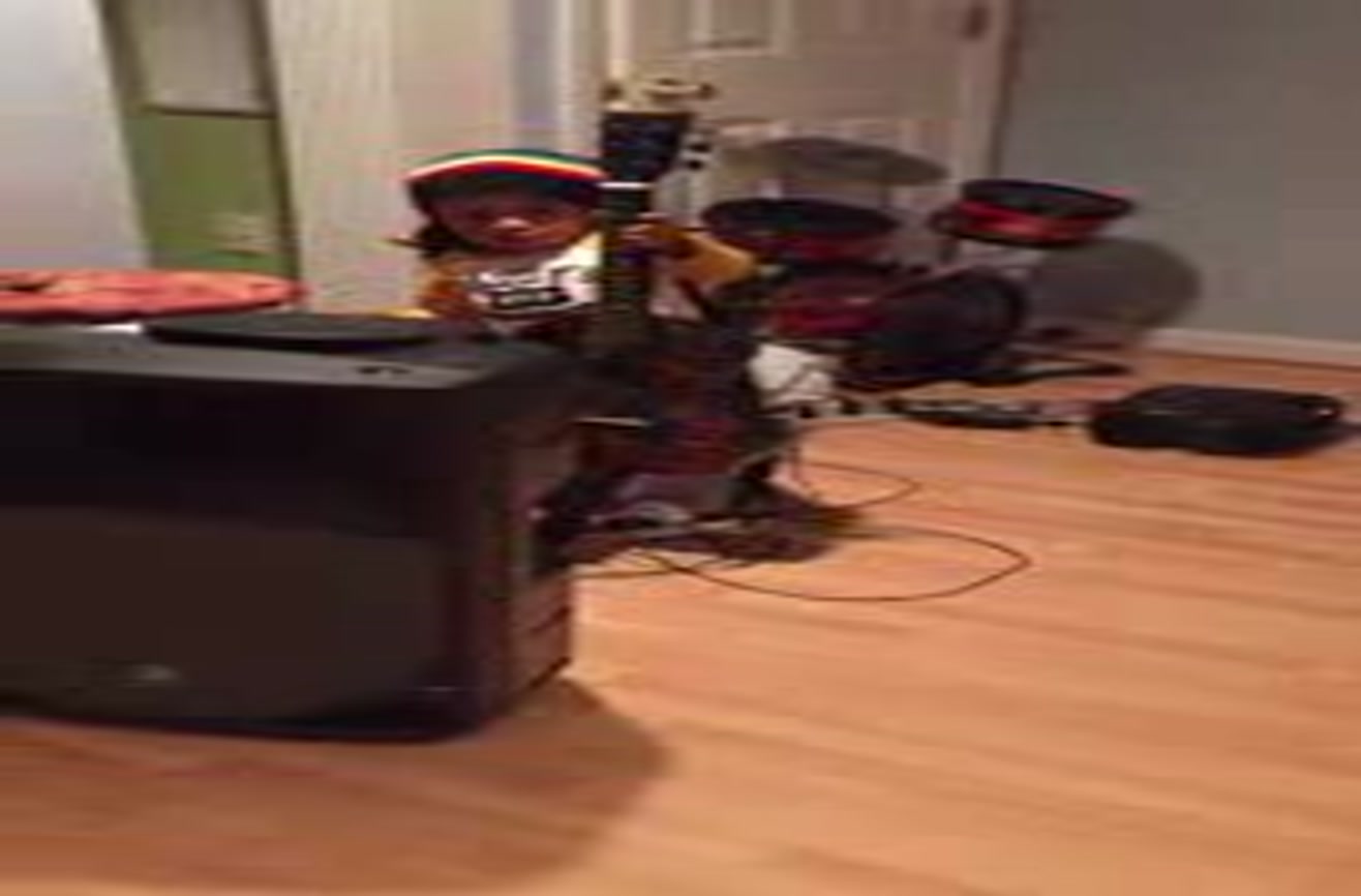 Two-year-old mini Bob Marley performs live.