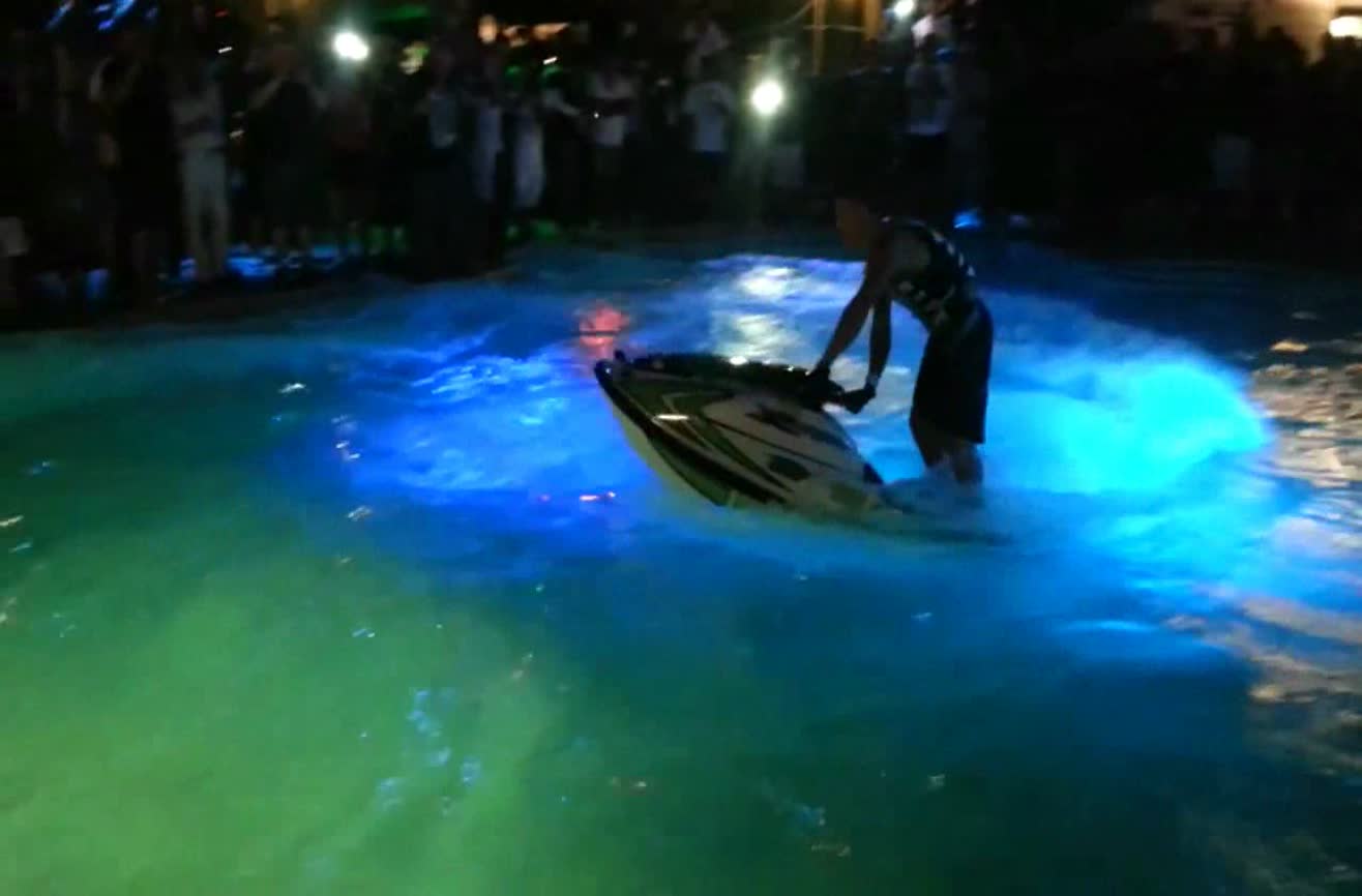 Jet ski backflips in a pool.