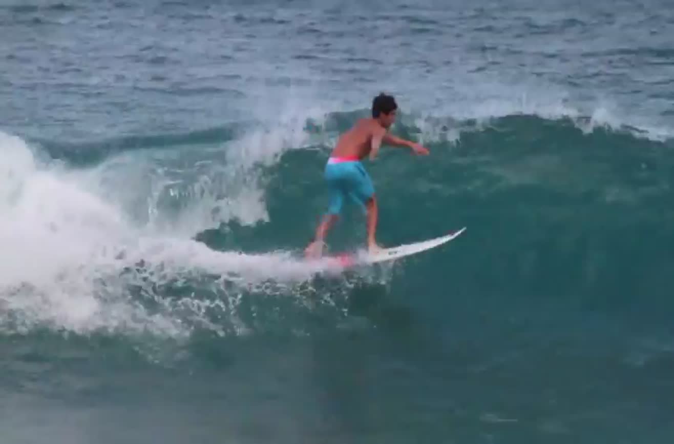 Surfer does a backflip while surfing.