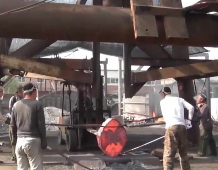 Watch blacksmiths use a huge, five-story hammer to forge a piece of metal.