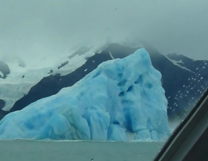 Iceberg flips over.
