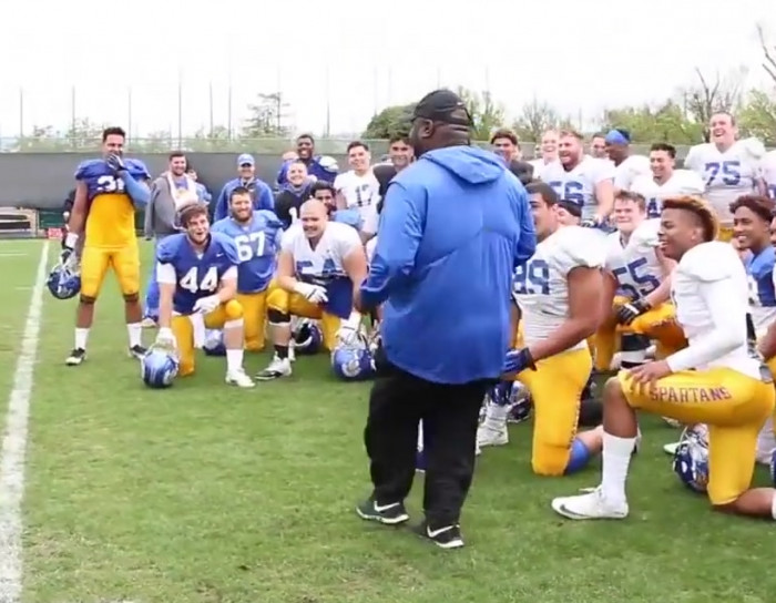 San Jose State football coach busts a move on the field.
