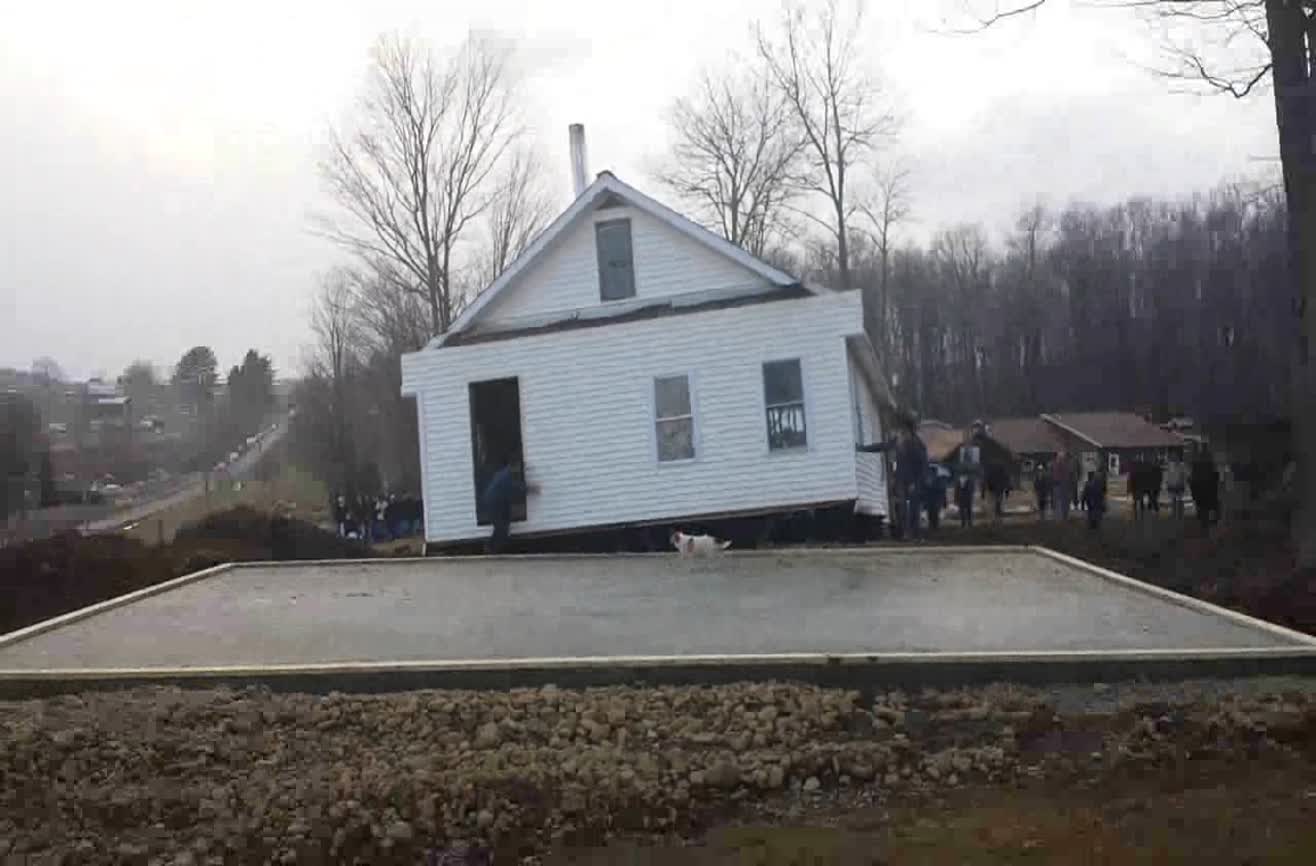 80 Amish people pick up and move a house.