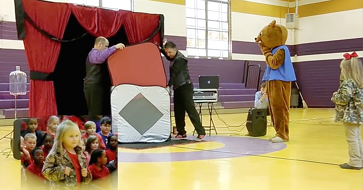 Soldiers surprise their daughter at a school magic show.