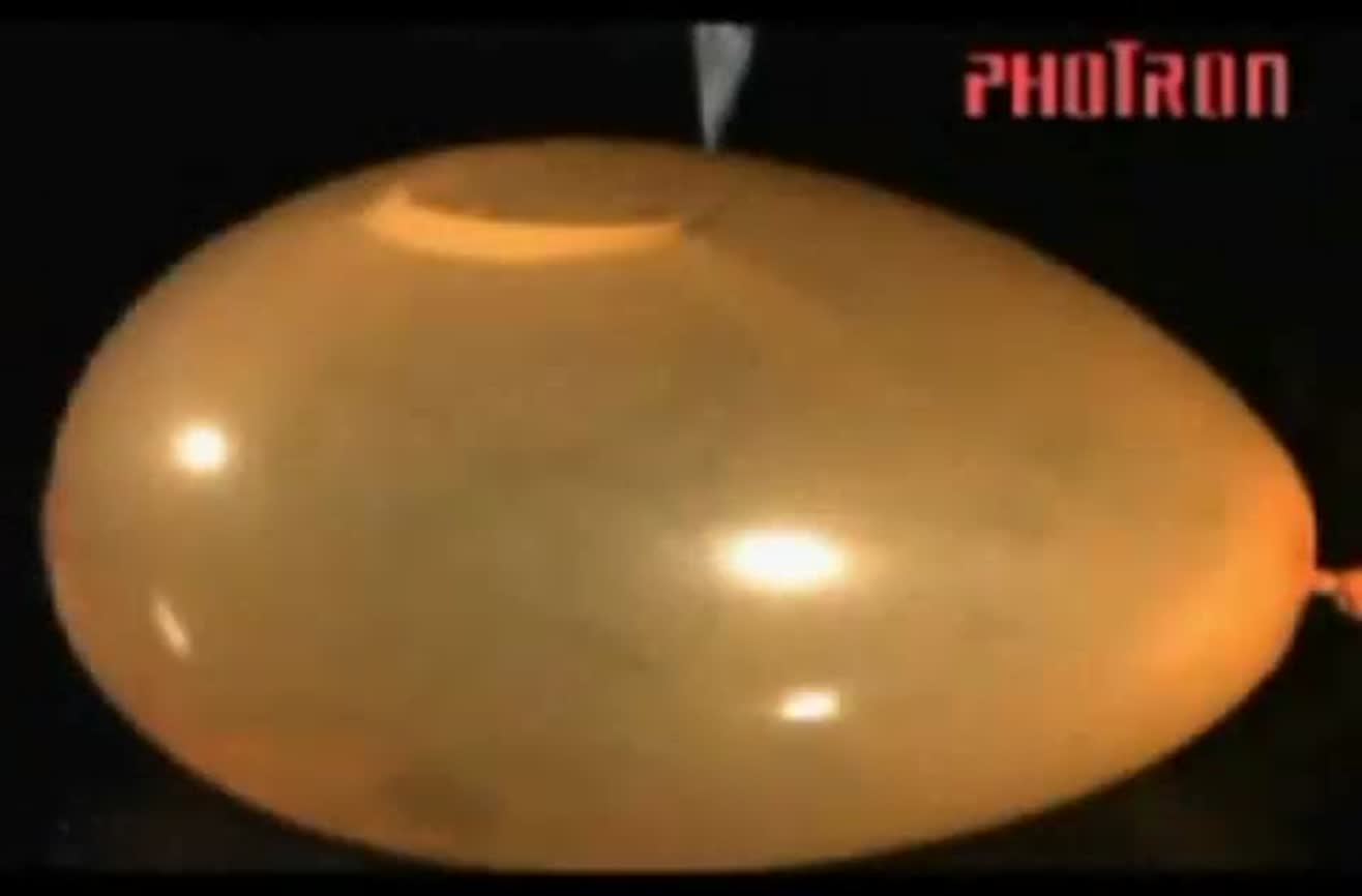Balloon explodes in slow motion.