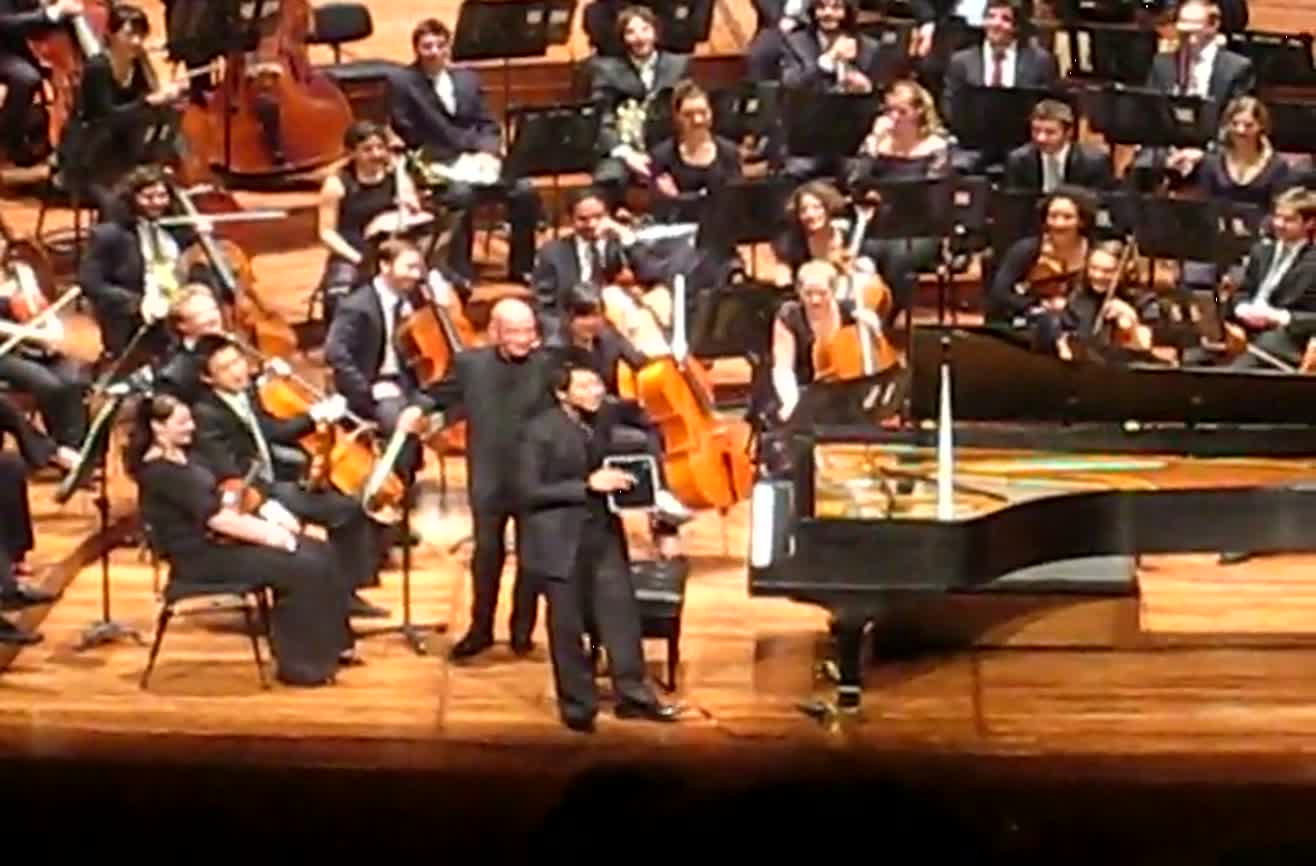 Concert pianist plays iPad on stage.