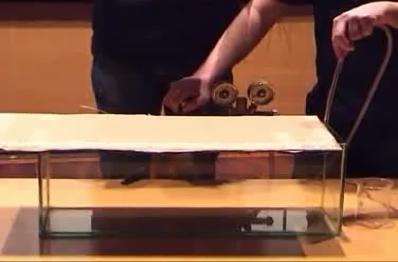 Model boat floating on sulphur hexafluoride, a very dense gas.