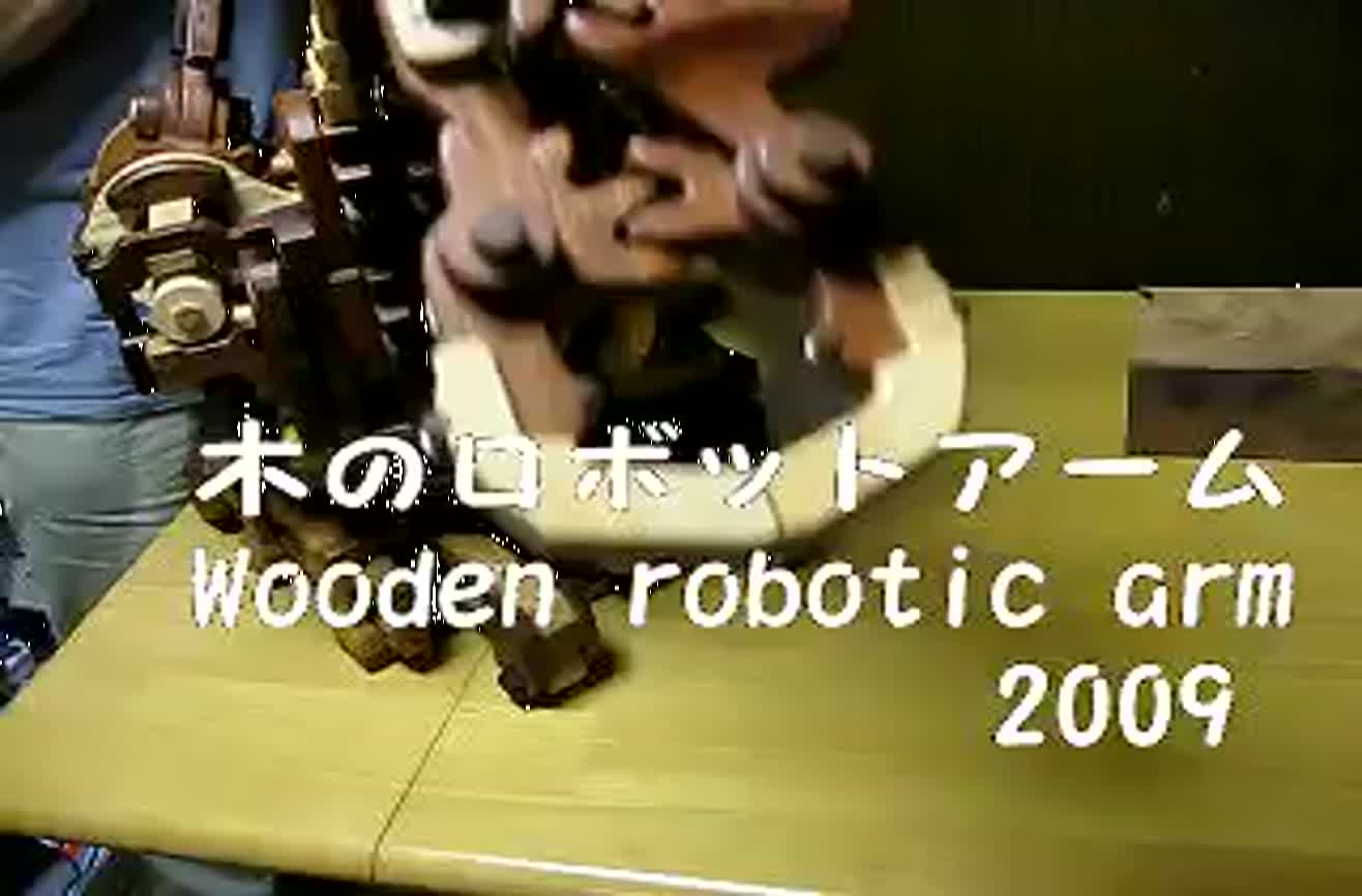 Wooden hand-operated robotic arm.