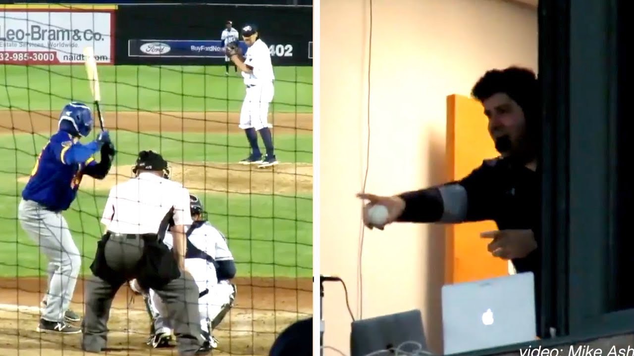 Baseball announcer catches ball while calling game.