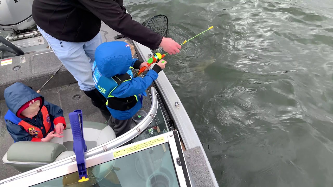 Little boy's first fish catch is the big one.