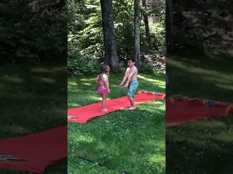 Big brother teaches his sister the best technique for sliding down a ...