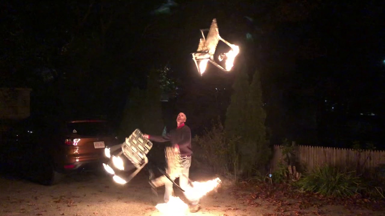 Flaming lawn chair juggling