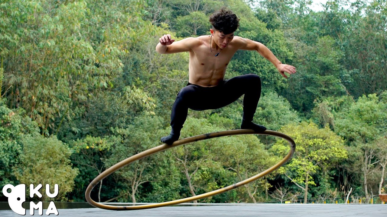 Man performs circus-like dance within giant hoop