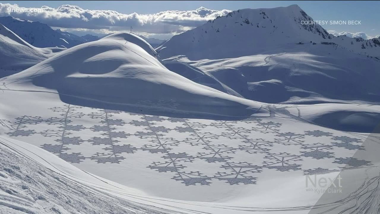 Artist walks for hours in snowshoes to make snow art
