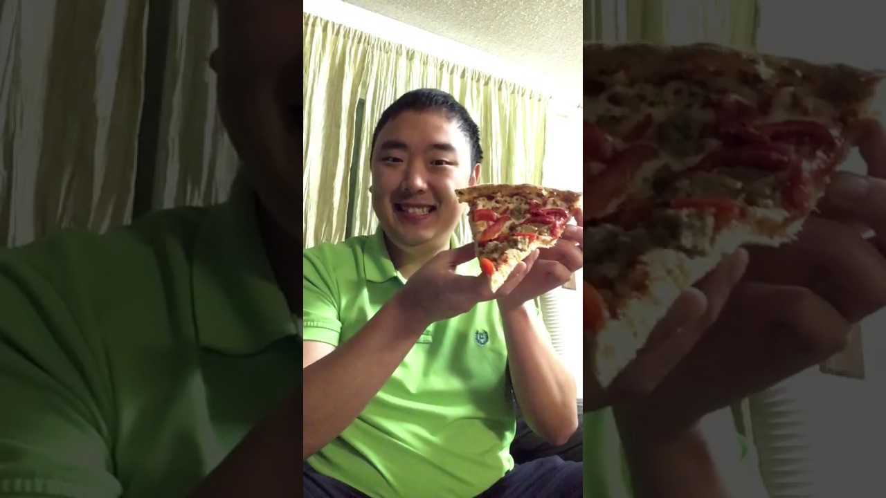 Man eats entire slice of pizza in one big bite