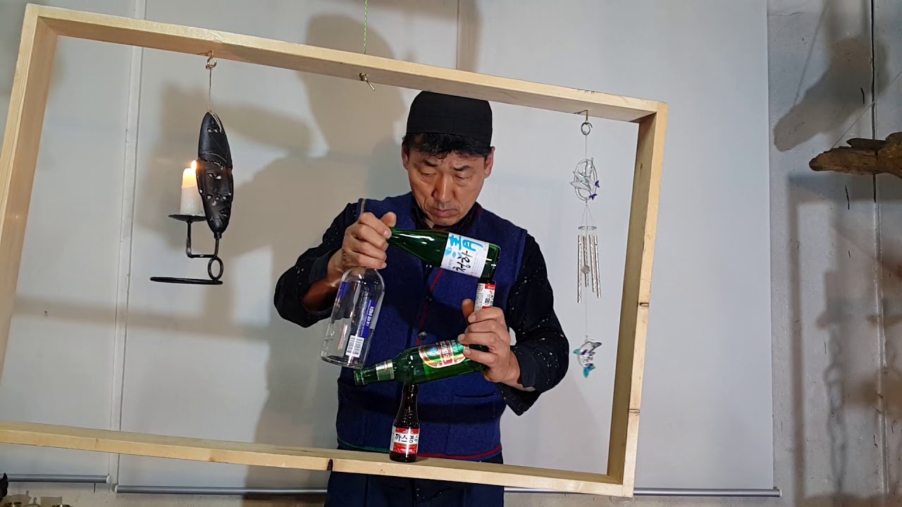 Balancing bottles on shaky square frame.