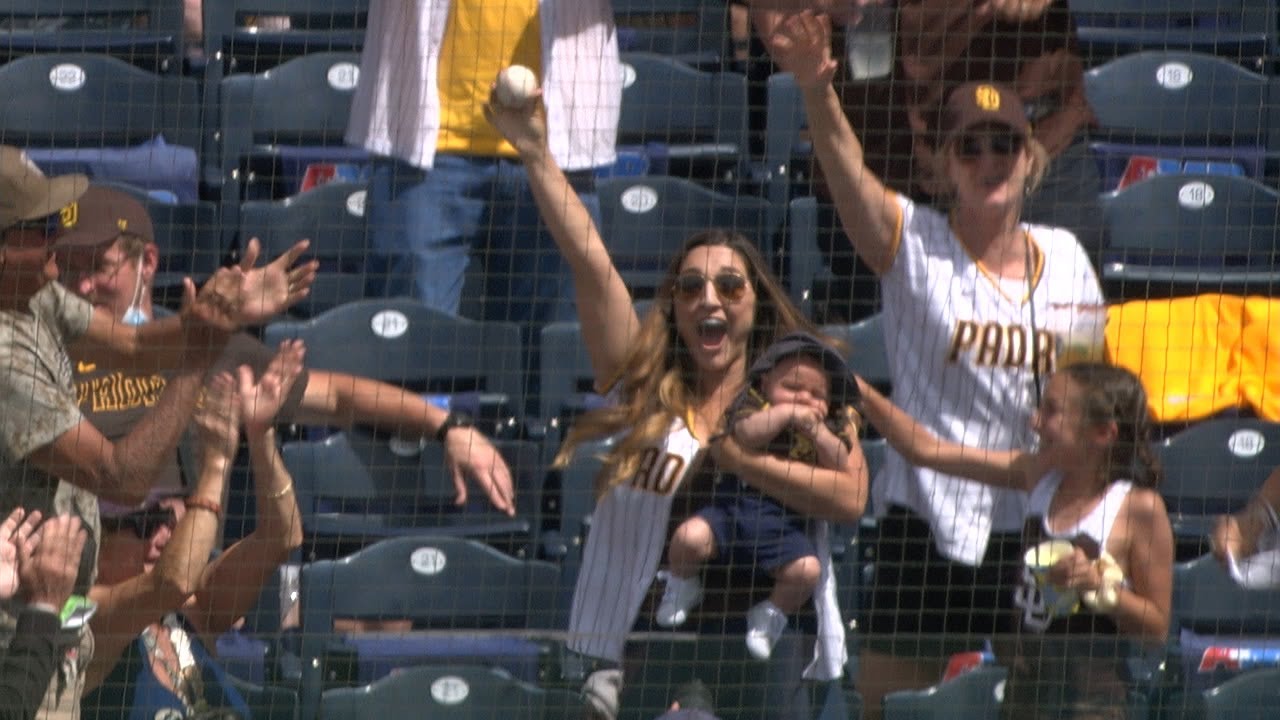 Padres fan makes incredible foul ball catch while holding a baby
