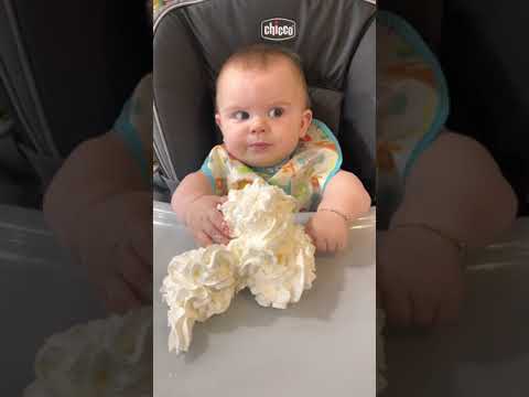 Baby's first encounter with canned whip cream.