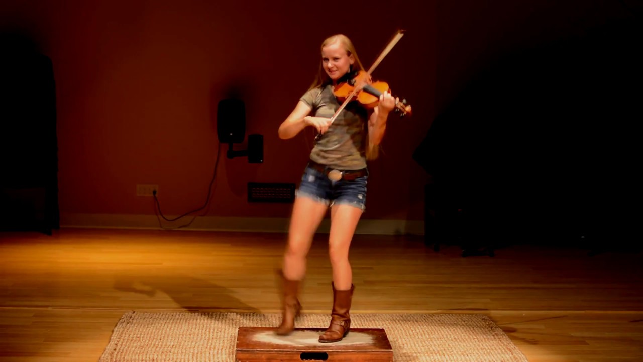 Playing violin and dancing to 'Cotton-Eyed Joe.'