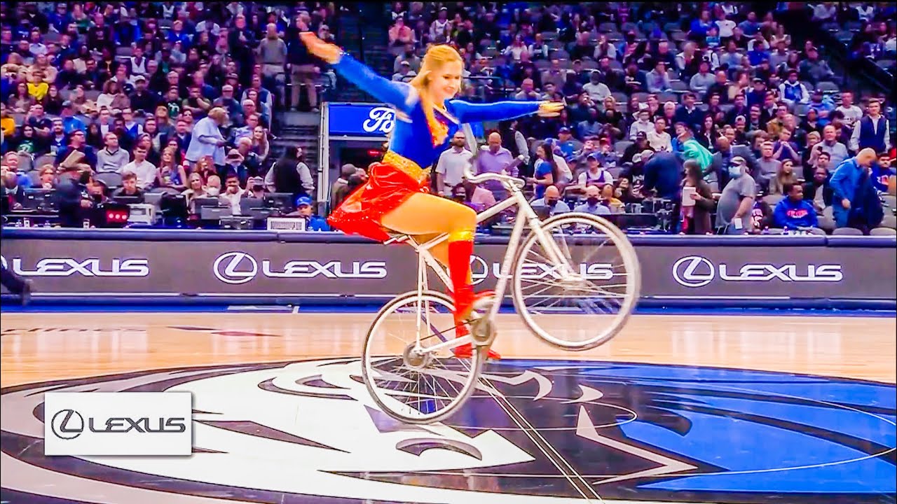 Supergirl bike performance during NBA halftime.