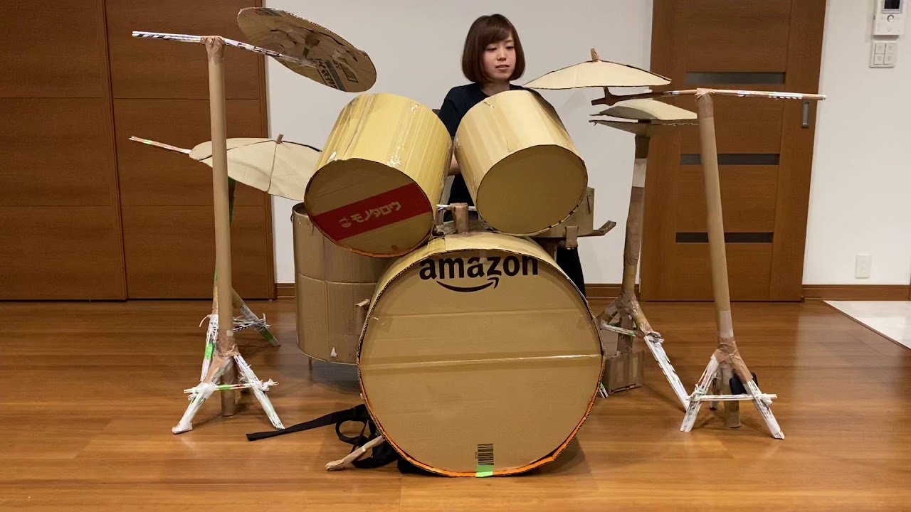 Playing the cardboard drums.