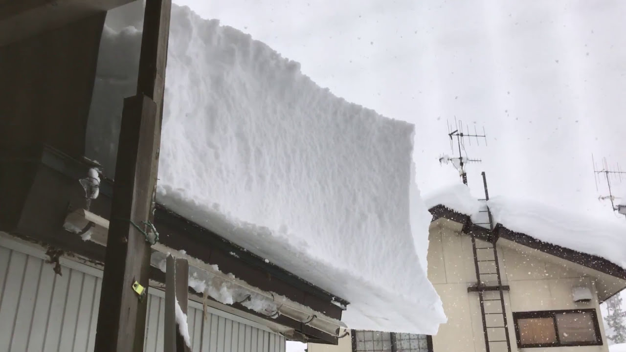 Giant snow mound slides off roof.