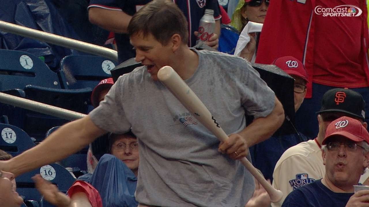 Fan catches rogue baseball bat, gets a kiss.