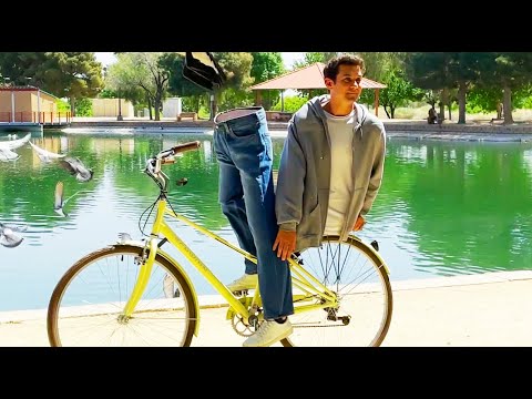 Man cut in half rides bike.