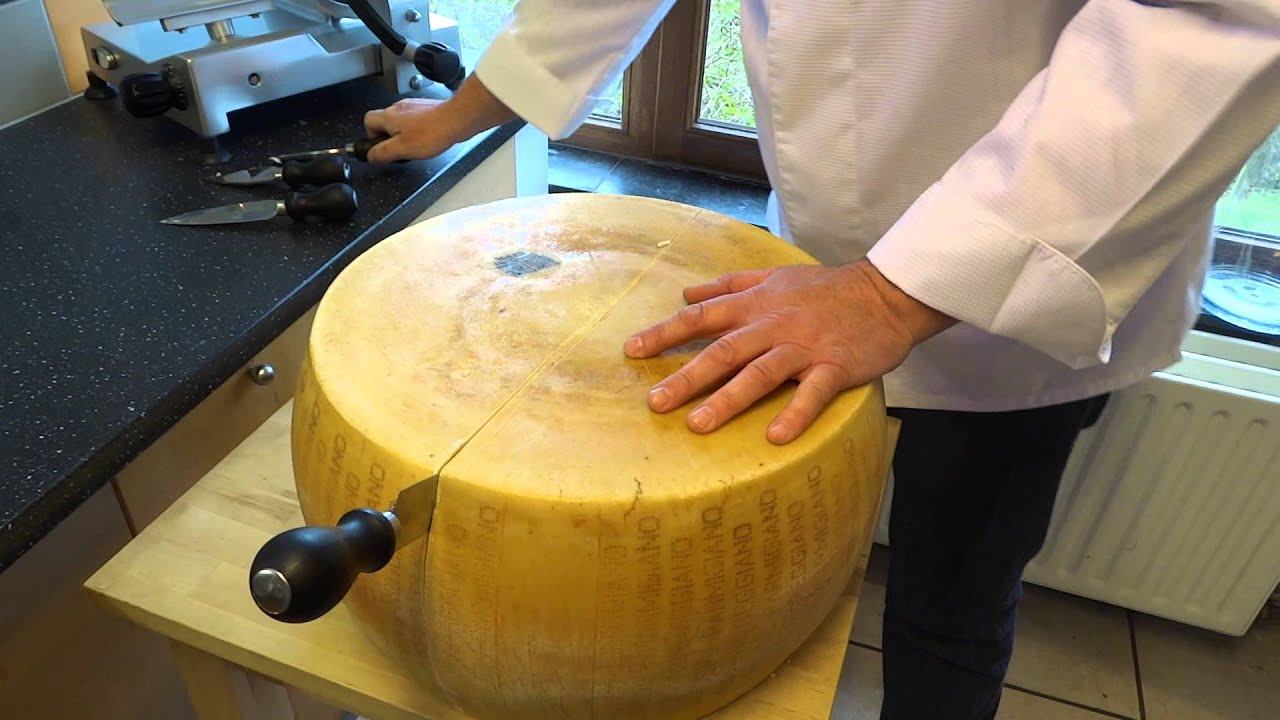 Cracking open a wheel of parmesan cheese.