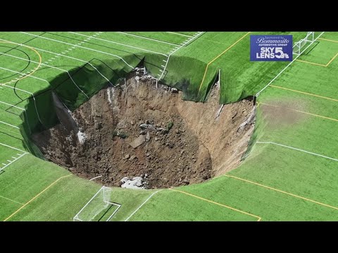 Moment sinkhole swallows 100-foot hole in soccer field.
