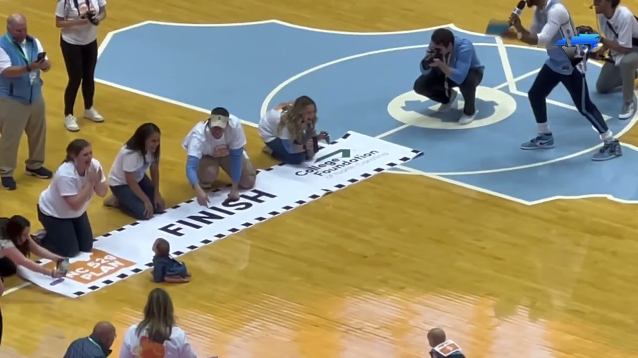 Babies race on UNC basketball court.