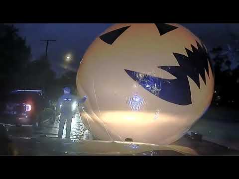 Officer vs. giant inflatable pumpkin.